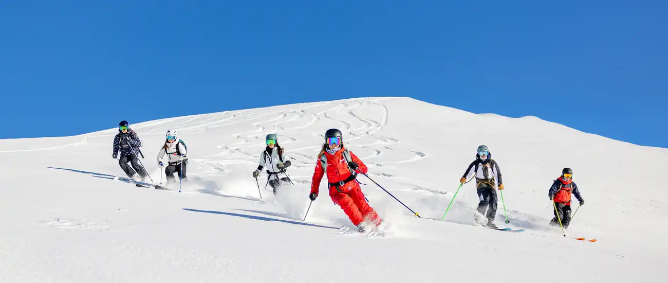 How should you warm up before a skiing lesson?